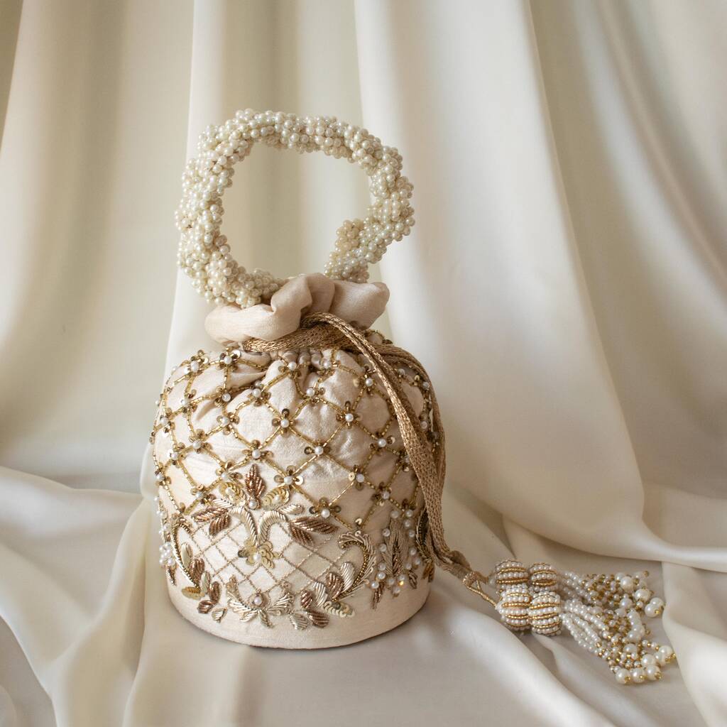 Isha Cream Silk Potli Bag By Atiya Choudhury